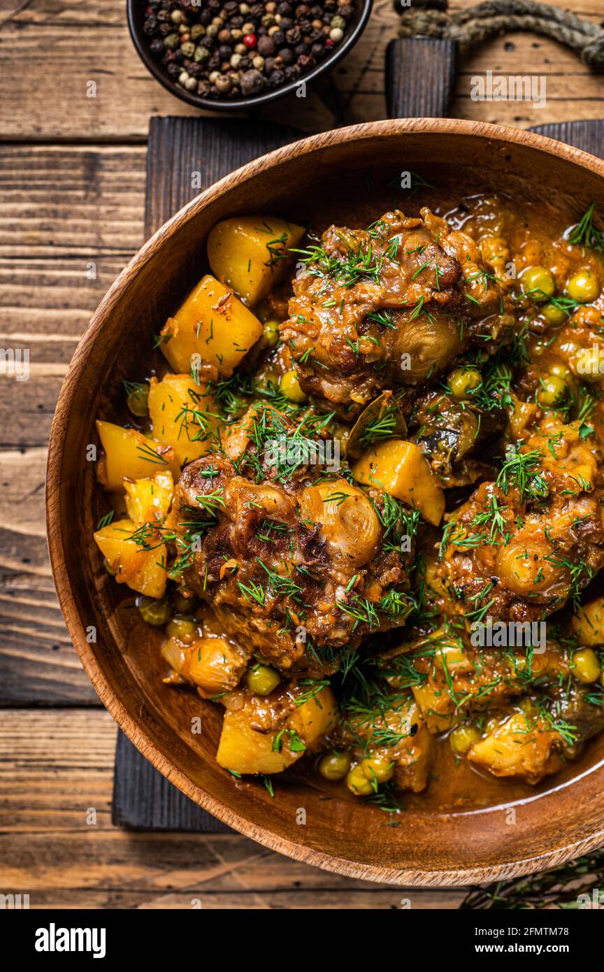 Lamb oxtails tails stew with vegetables in a wooden plate. wooden ...