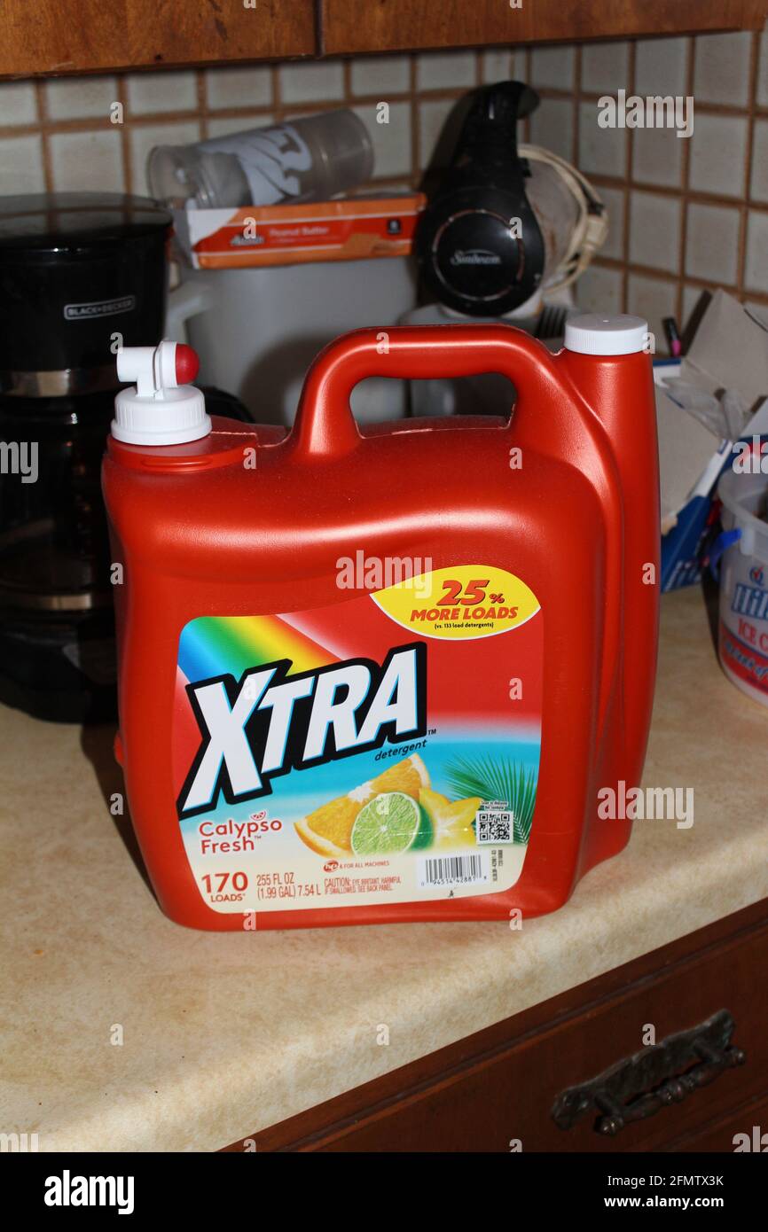 Xtra Laundry detergent that's bright and colorful on a counter top shot ...