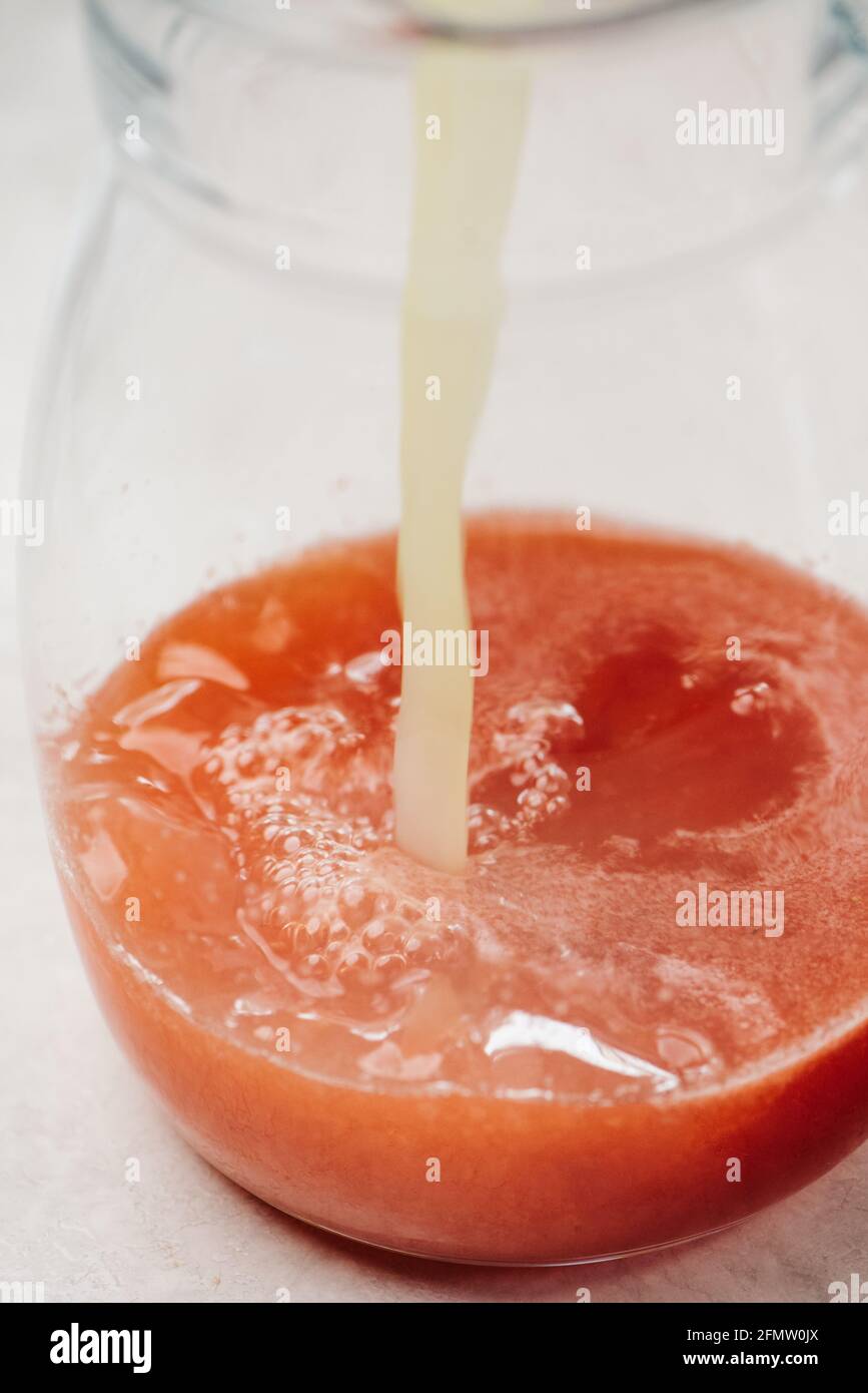 Mixing lemon juice into strawberry for a strawberry lemonade Stock ...