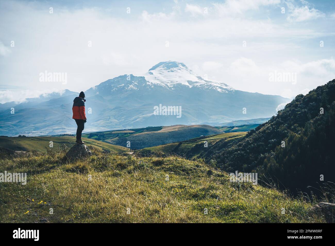 Man standing in front of Cayambe volcano with a beautiful view Stock ...