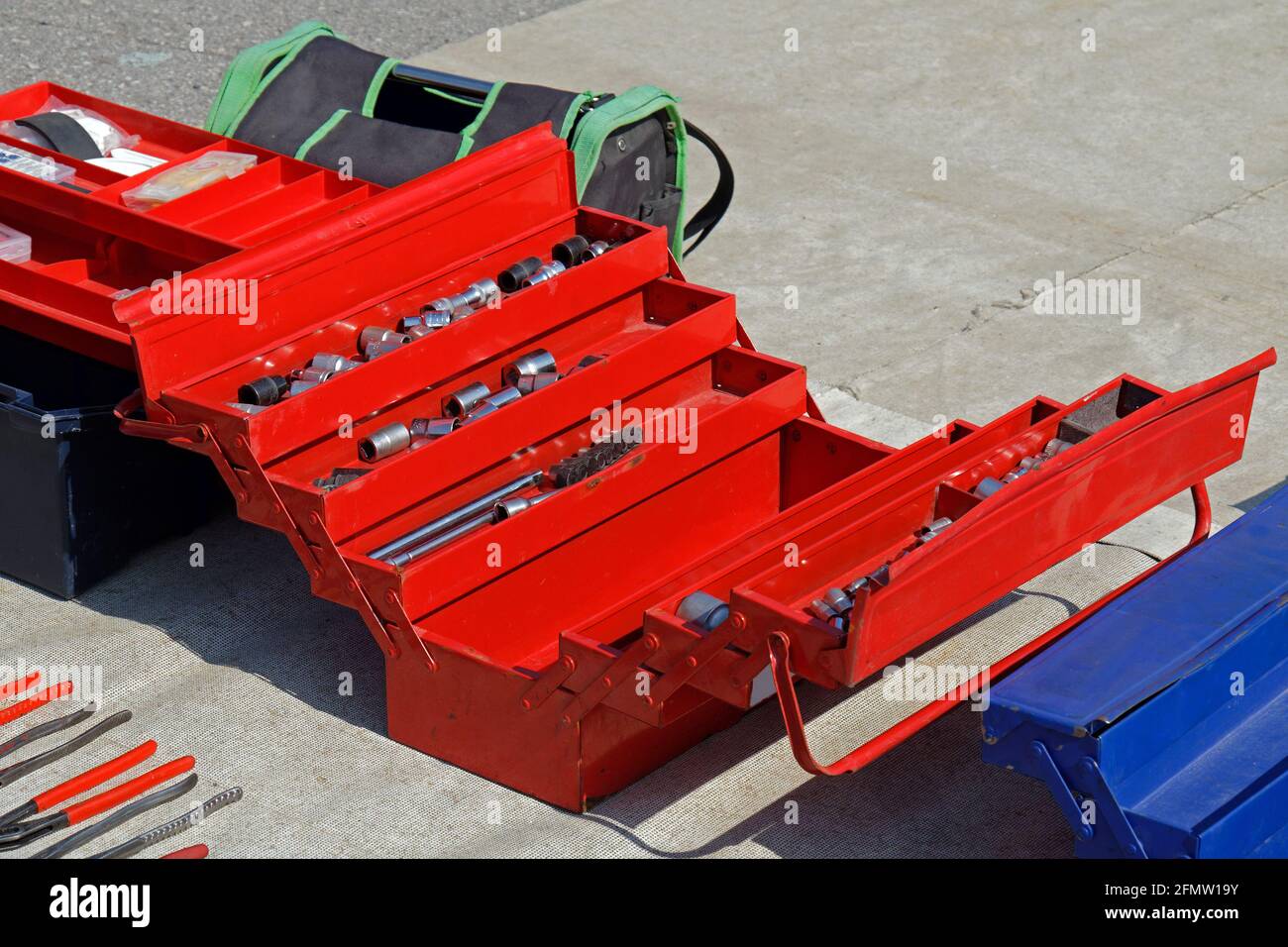 Open professional metal storage tool box on pavement Stock Photo - Alamy