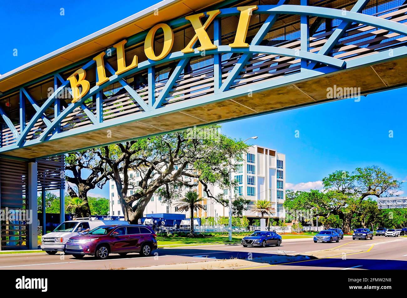Traffic travels on Highway 90 beneath a Biloxi sign on a pedestrian ...