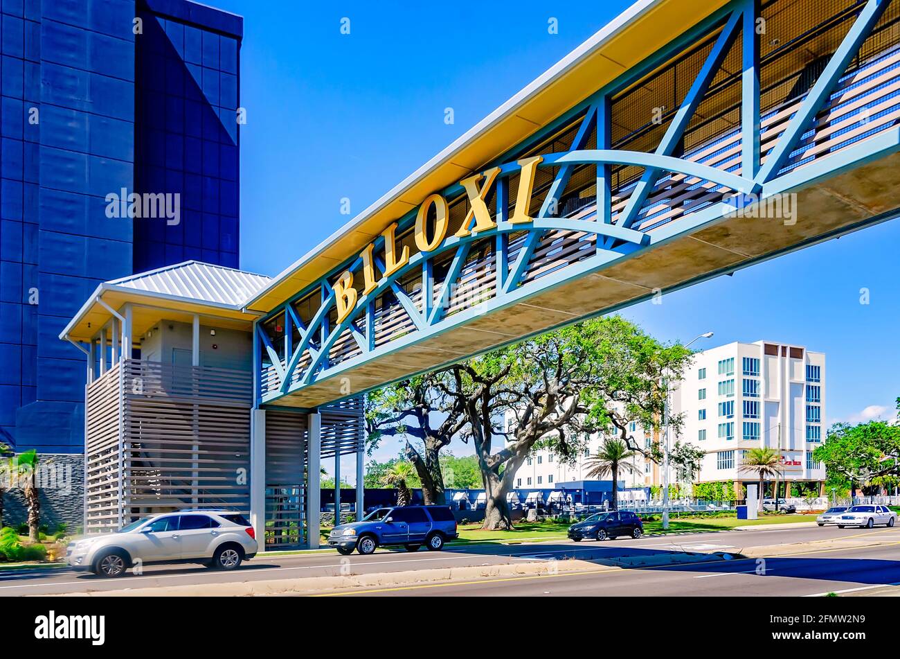 Traffic travels on Highway 90 beneath a Biloxi sign on a pedestrian ...