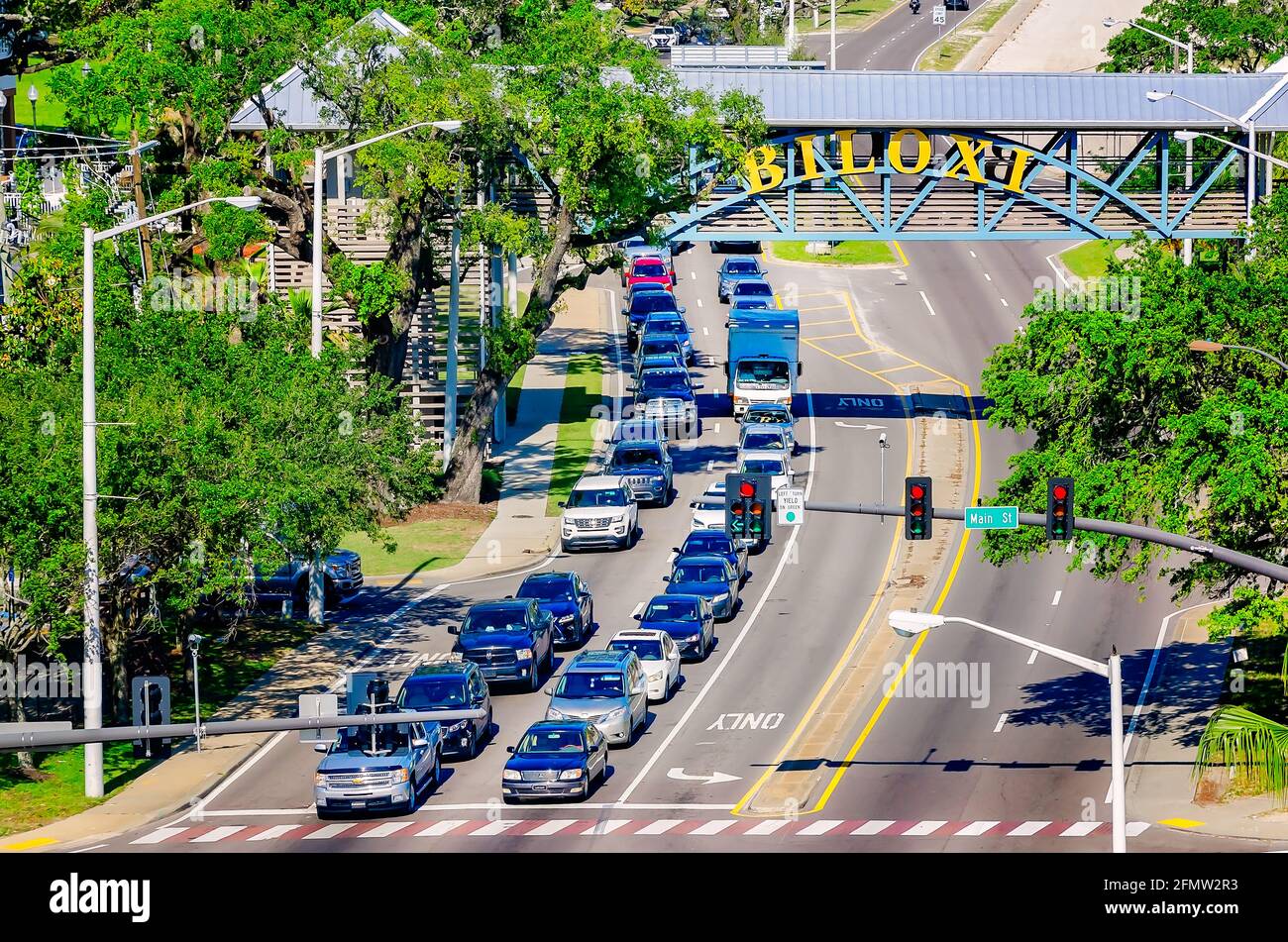Traffic travels on Highway 90 beneath a Biloxi sign on a pedestrian ...