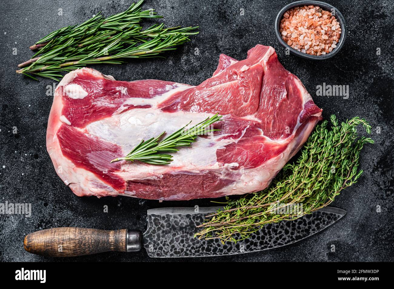 Fresh Raw lamb mutton shoulder meat with butcher knife. Black ...