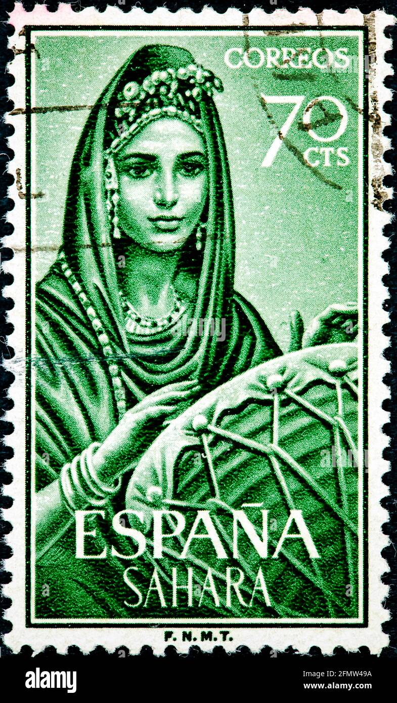 SPANISH SAHARA - CIRCA 1964: A stamp printed in Spain. Show: a girl ...