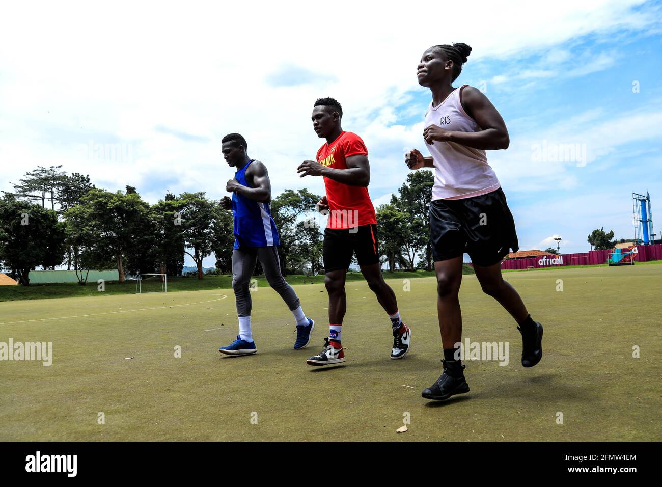 Kampala, Shadir Musa Bwogi (C) and Catherine Nanziri exercise during a ...