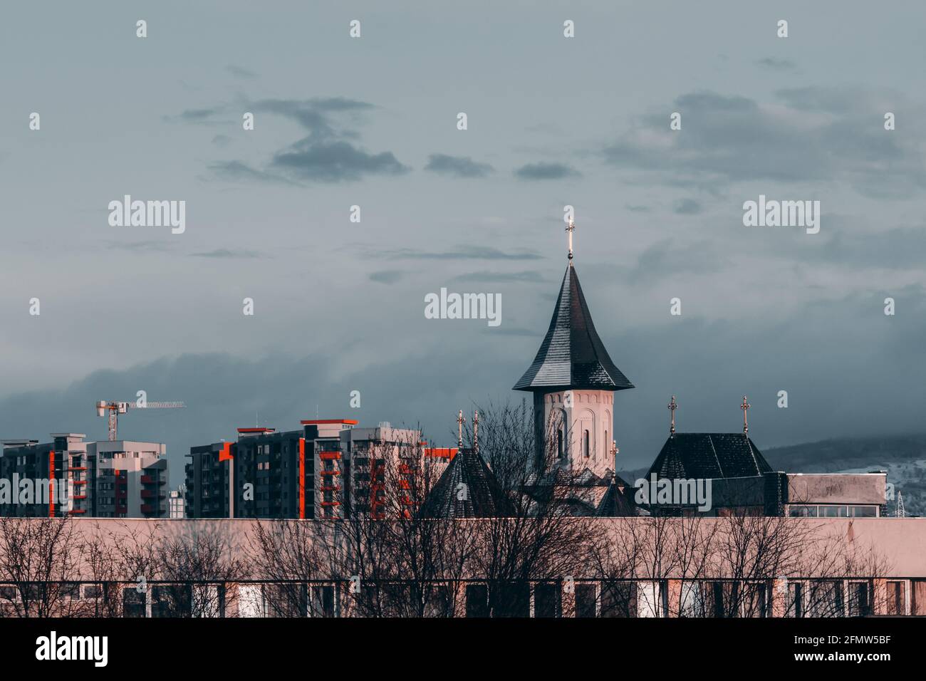 Roof of church and tall buildings on a gloomy sky background in Iasi ...