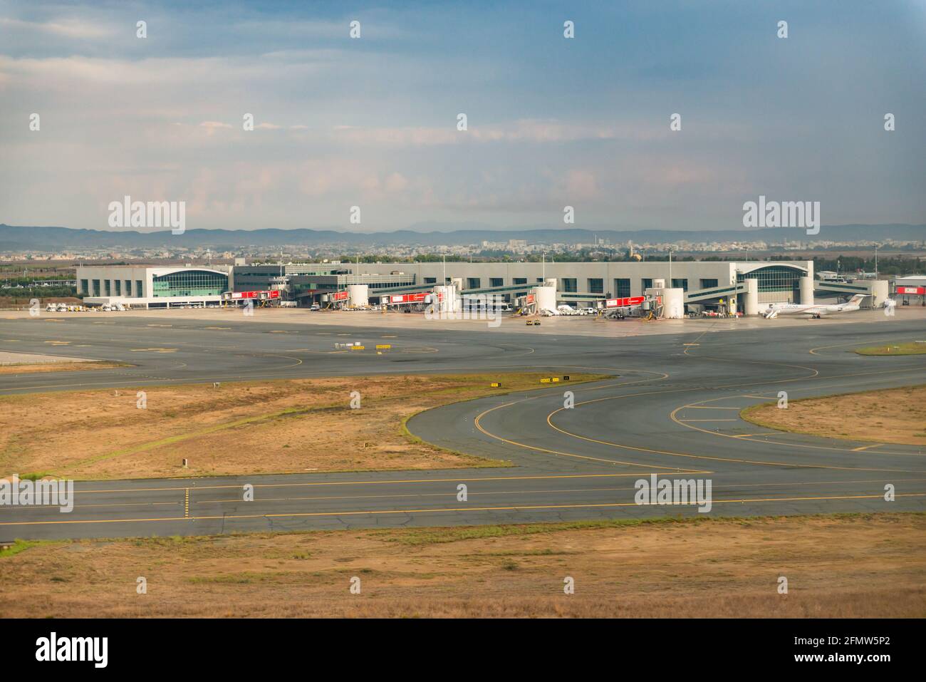 Paphos Airport in Cyprus. Planes on the runway and at the hangars ...