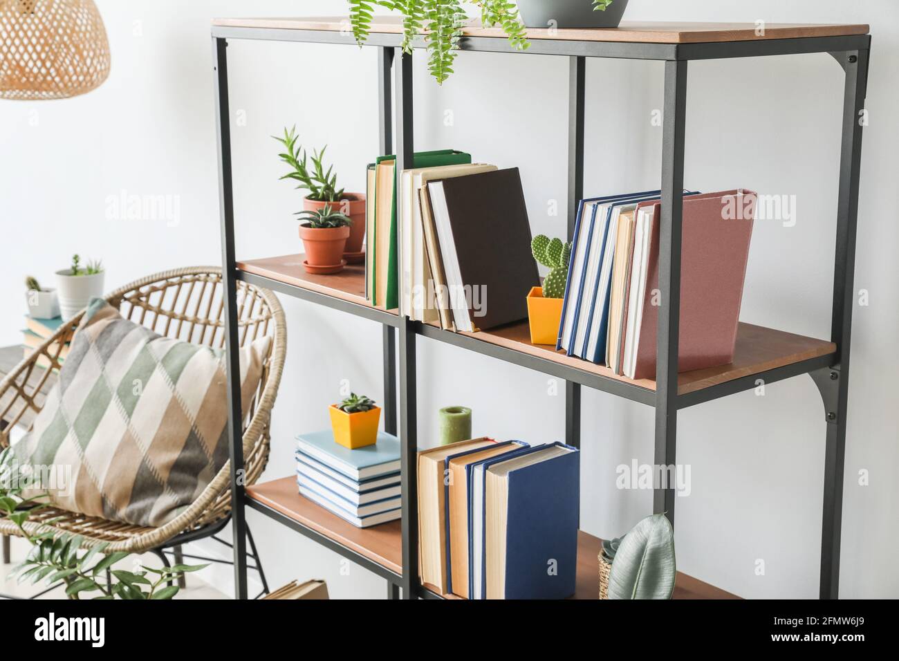 Interior of modern room with shelf unit and chair Stock Photo - Alamy