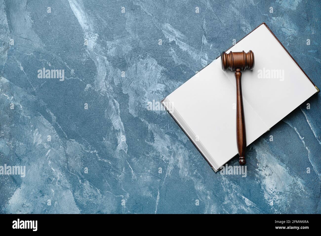 Judge's gavel and open book on color background Stock Photo - Alamy