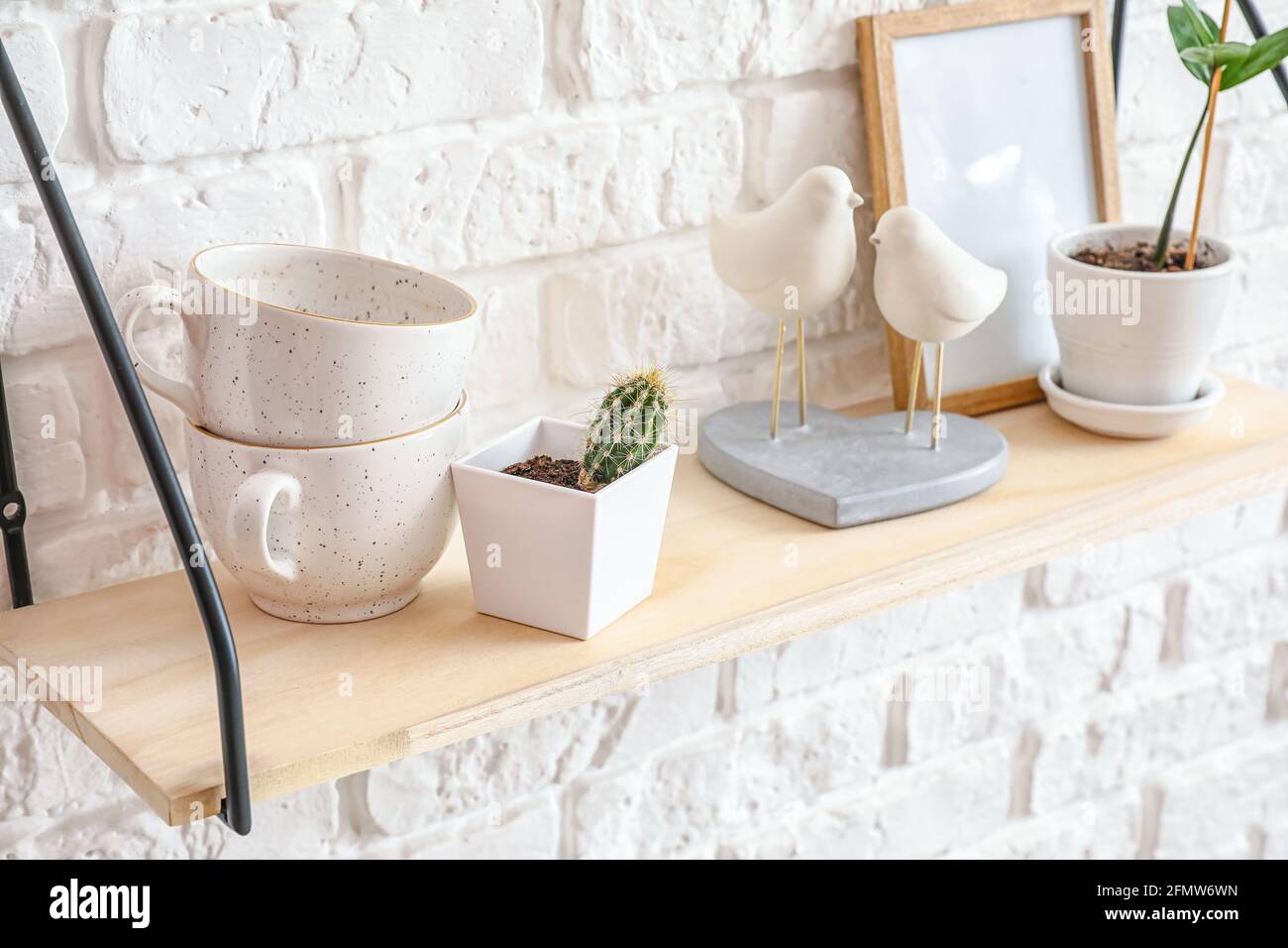 Hanging shelves on brick wall hi-res stock photography and images - Alamy