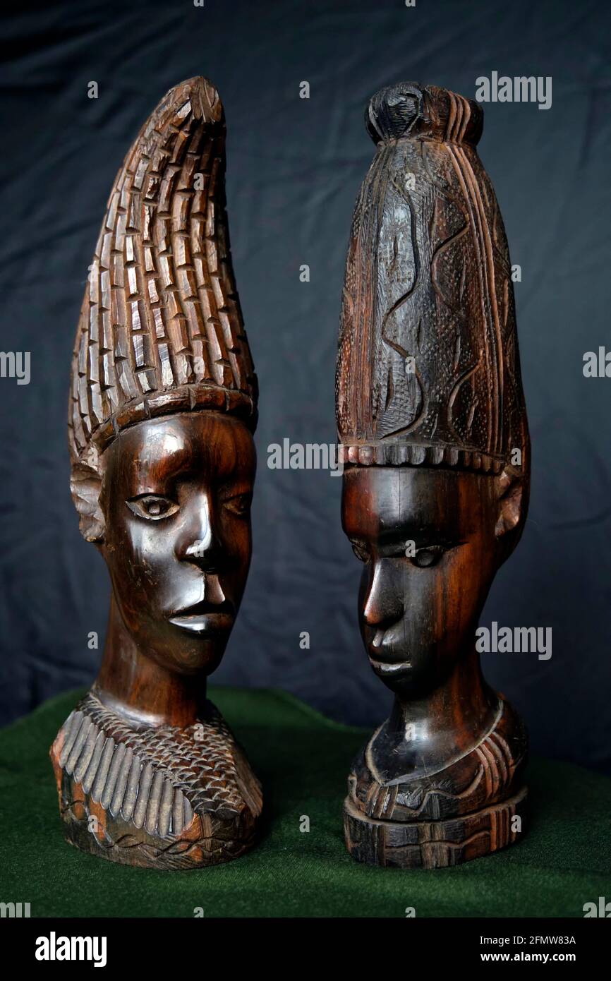 Hand carved wooden West African busts, male and female Stock Photo - Alamy