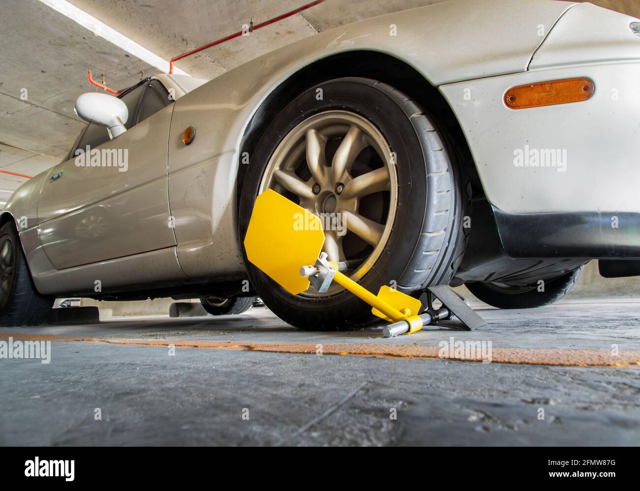 Car wheel blocked by wheel lock because illegal parking violation ...
