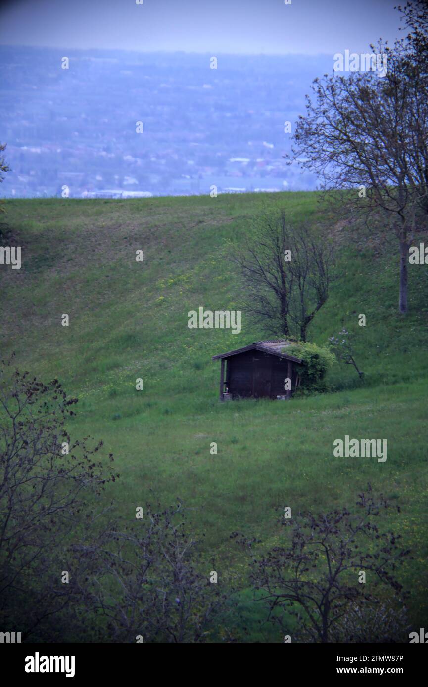 Wooden shack on a hill seen from the distance Stock Photo - Alamy