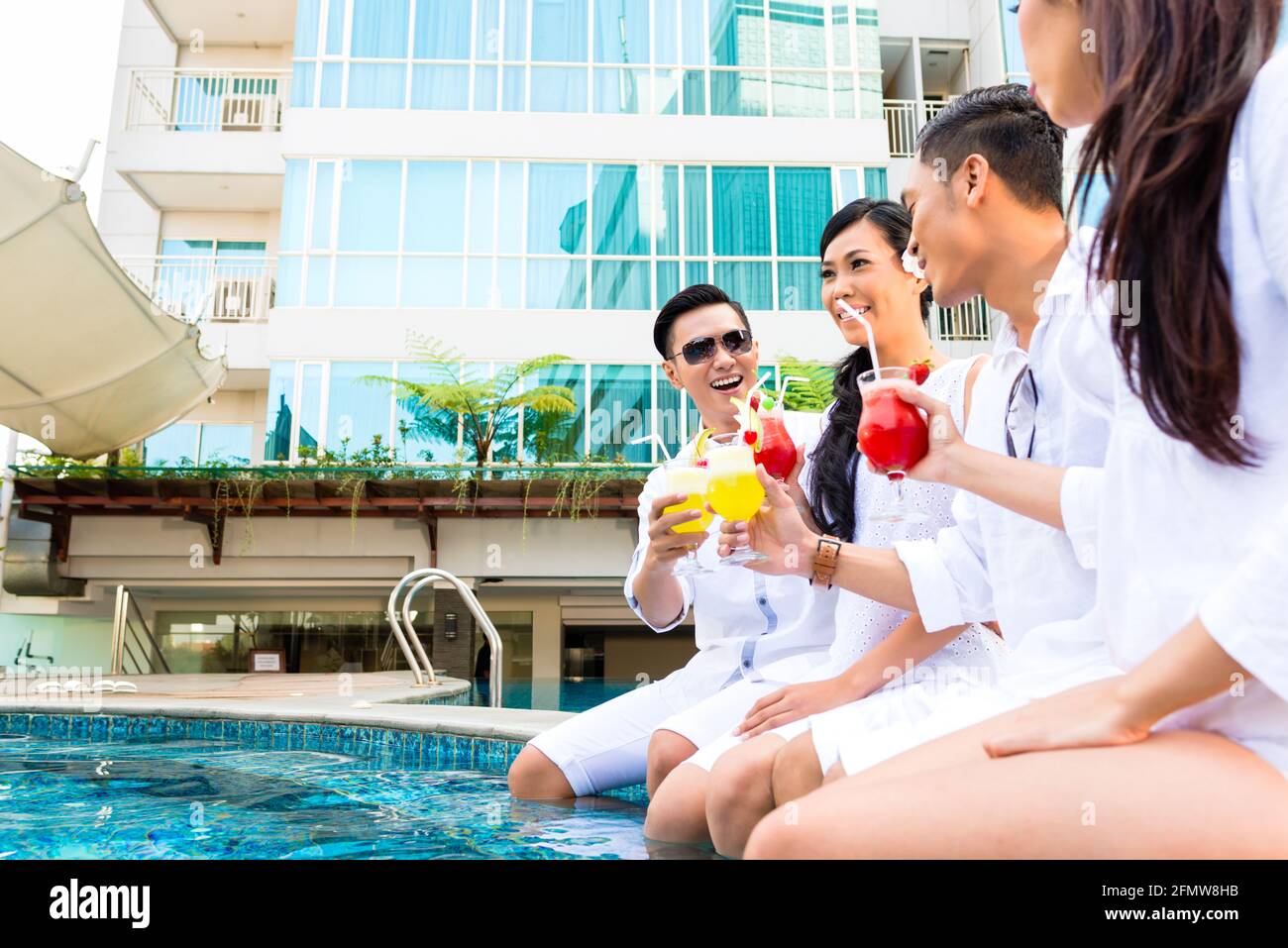 Woman laughing by pool and cocktail hi-res stock photography and images ...