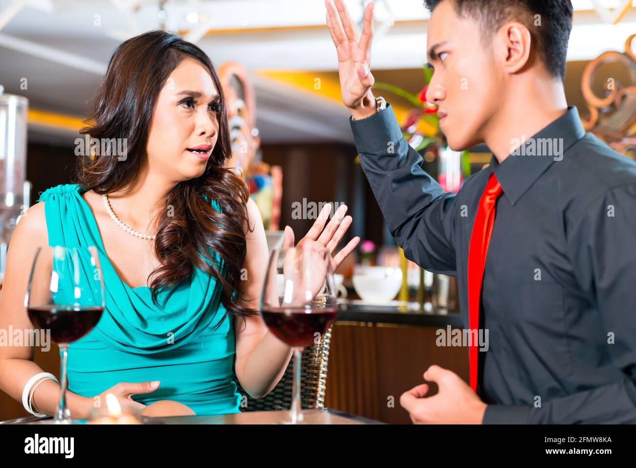 Asian Couple arguing in restaurant Stock Photo - Alamy