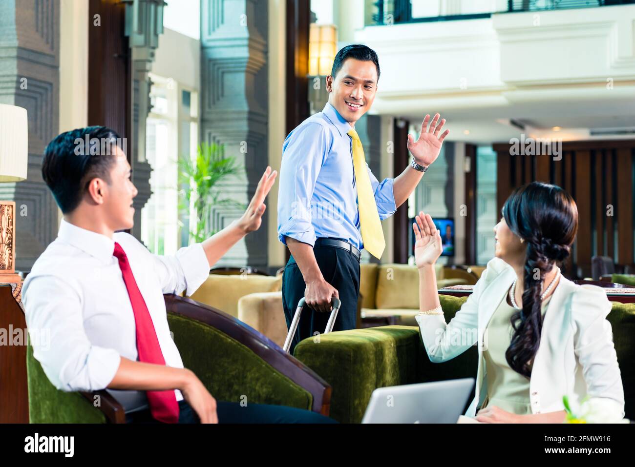 Asian Businesspeople saying goodbye in a hotel Stock Photo - Alamy