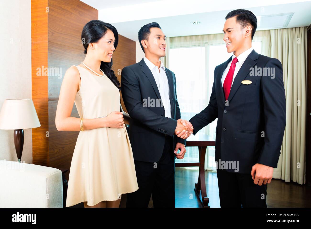 Manager greeting guests in hotel Stock Photo - Alamy