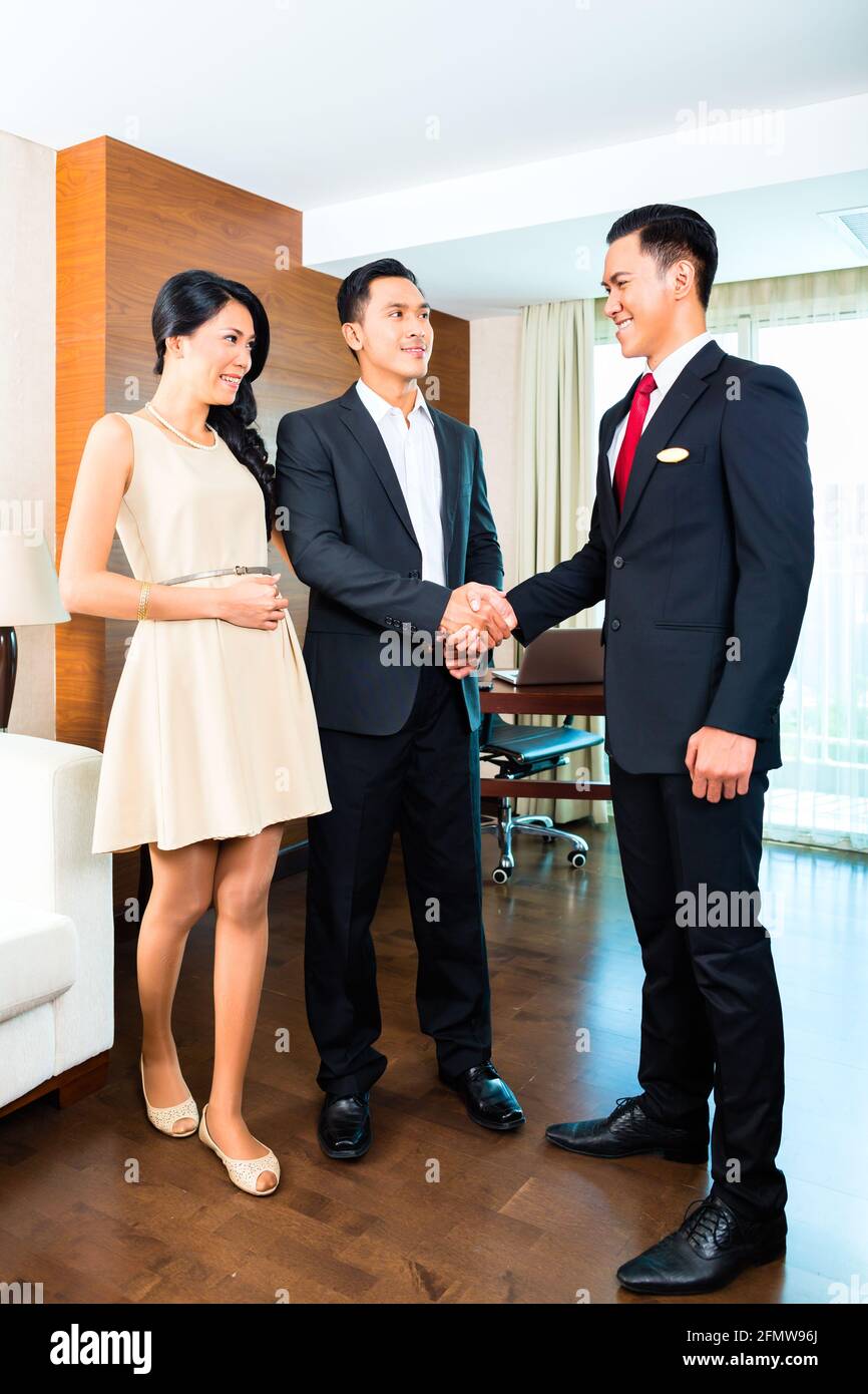 Manager greeting guests in hotel Stock Photo - Alamy