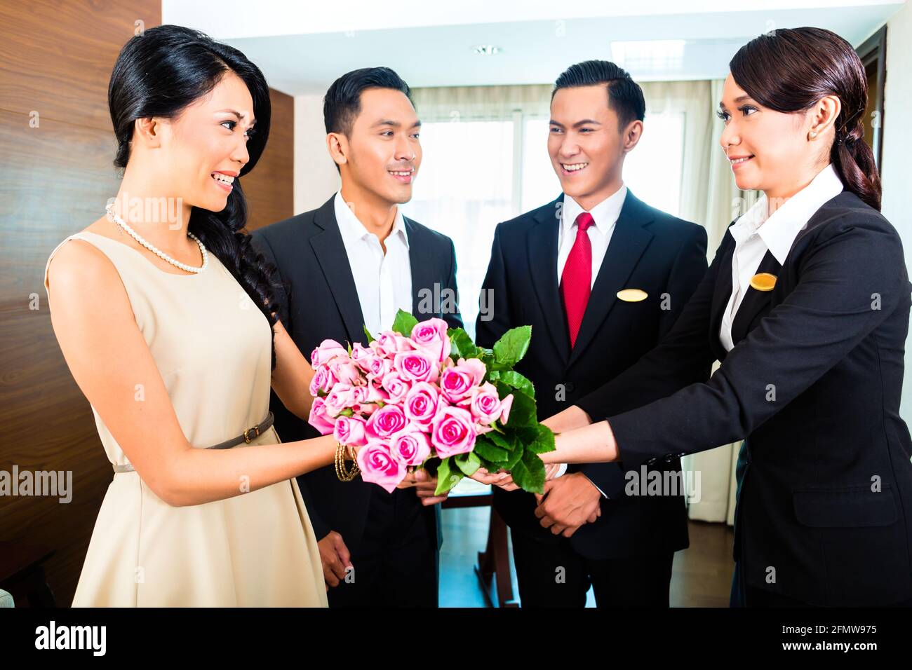 Staff greeting guests in hotel Stock Photo - Alamy