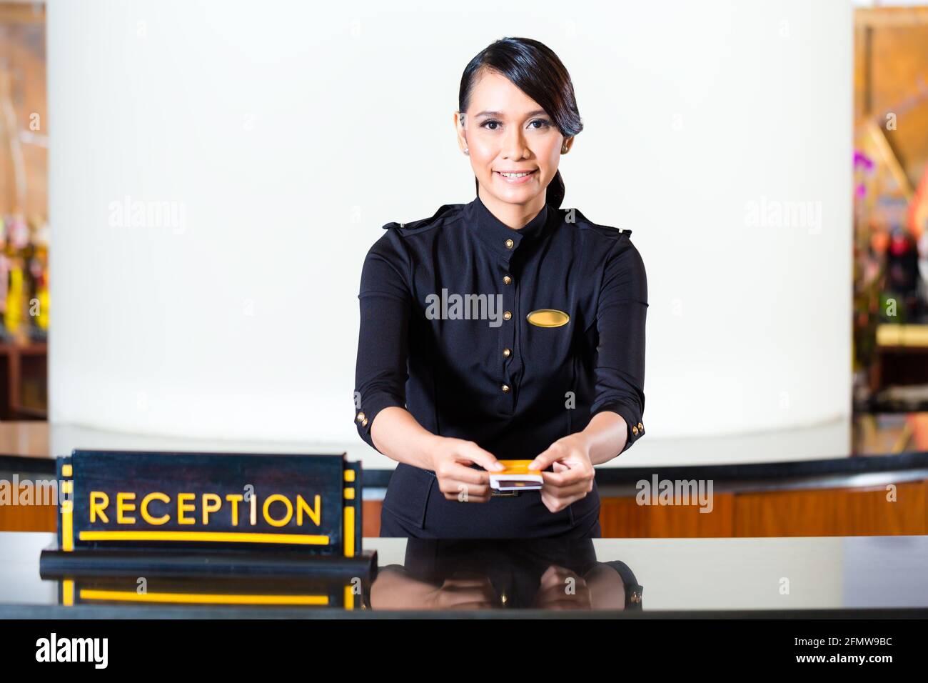 Portrait of receptionist passing keycard in hotel Stock Photo - Alamy