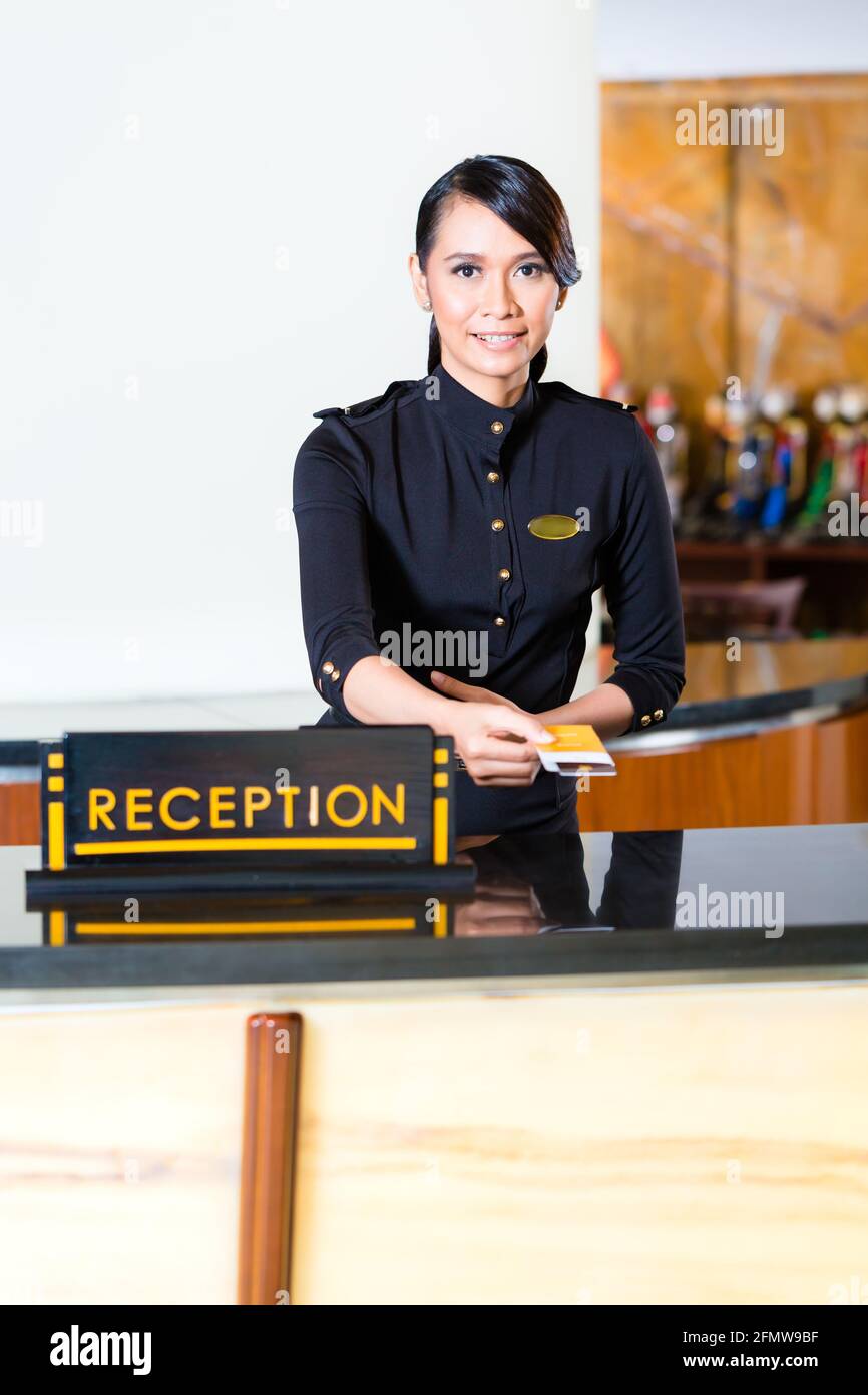 Portrait of receptionist passing keycard in hotel Stock Photo - Alamy