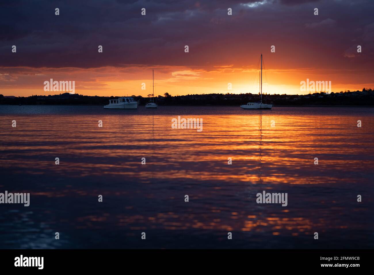 Yachts at Sunset Moored on Waitemata Harbour with Bright Orange Sky ...
