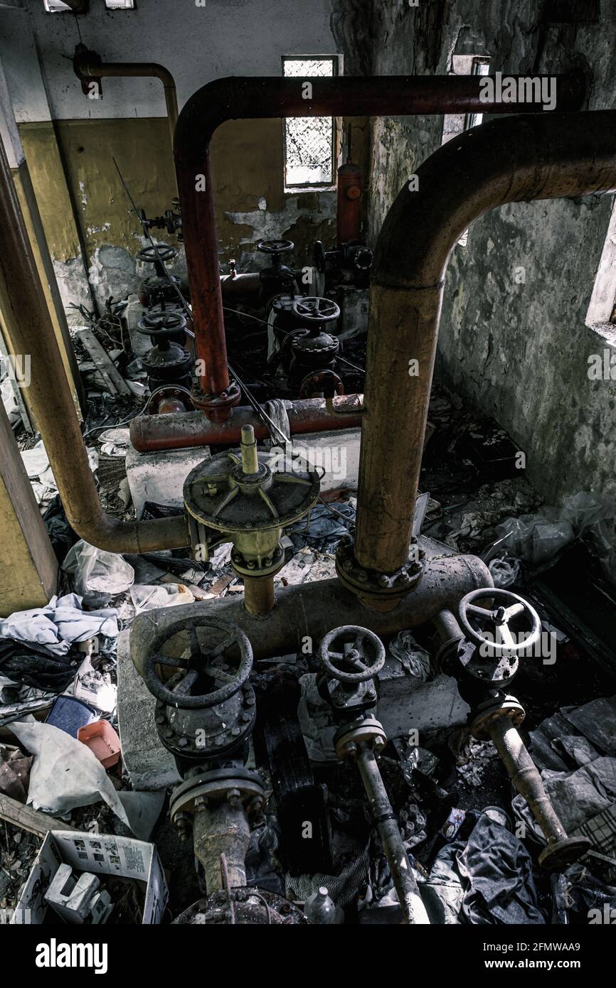 abandoned industrial area with pipes and taps Stock Photo - Alamy