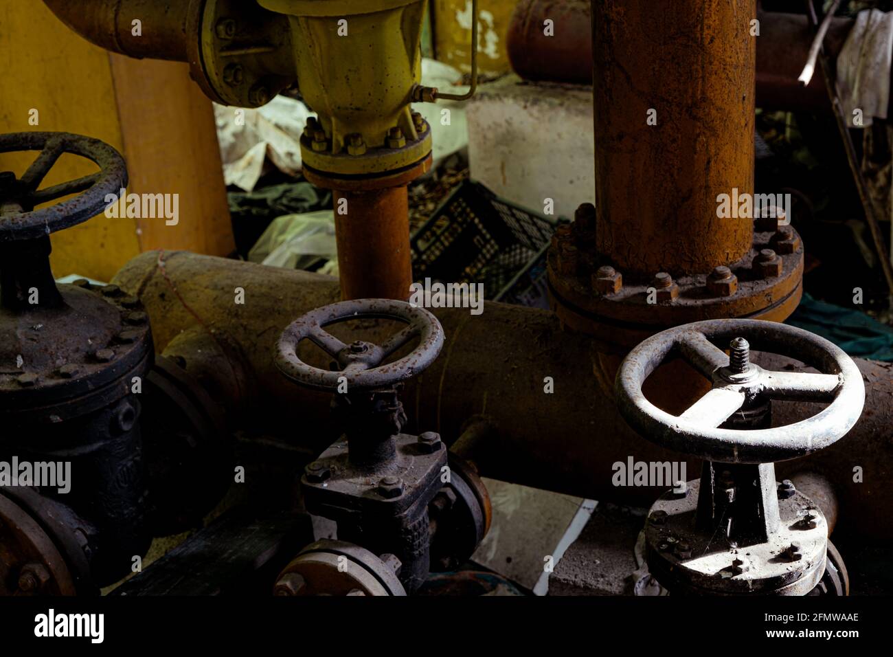 abandoned industrial area with pipes and taps Stock Photo - Alamy