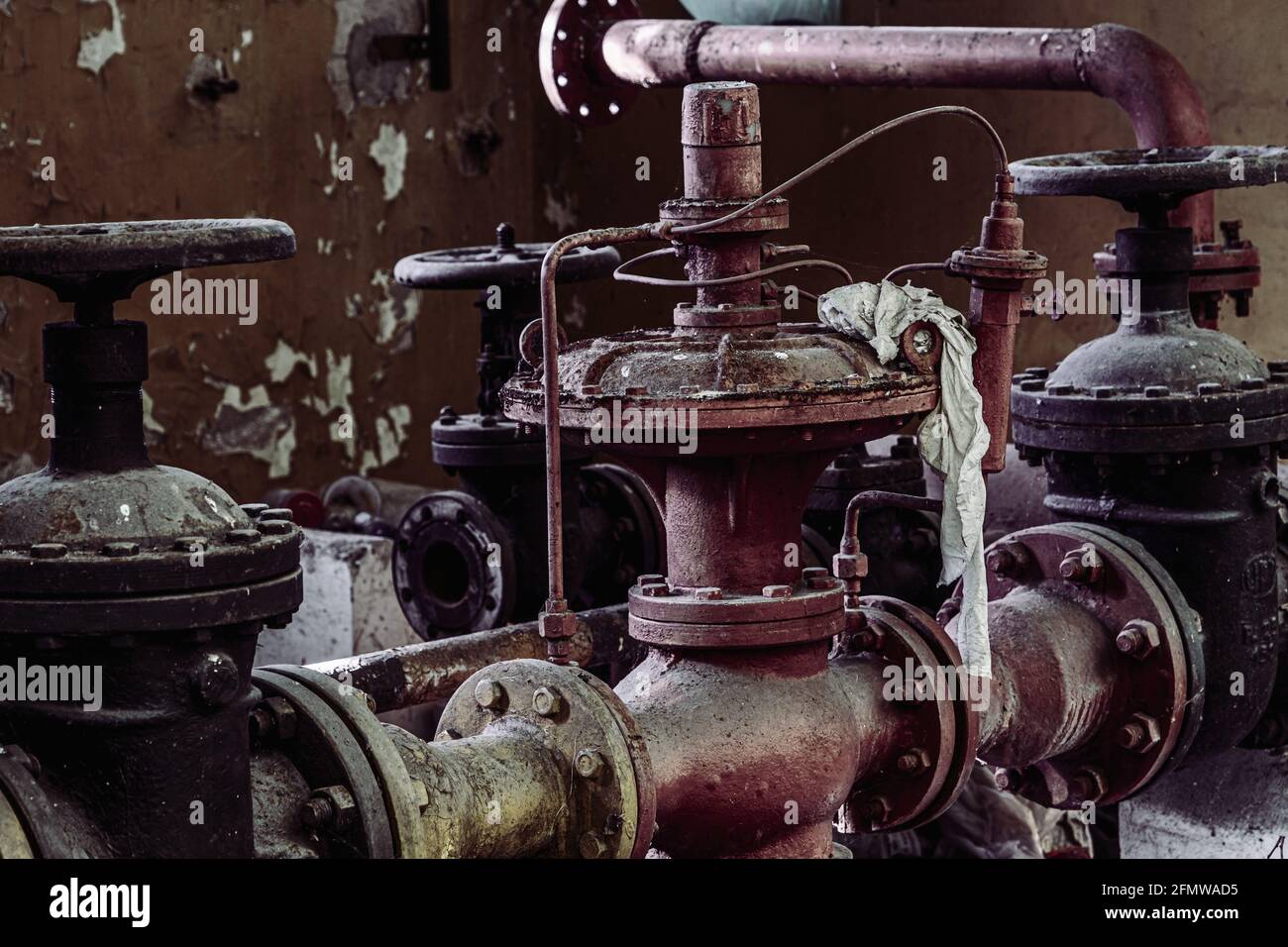abandoned industrial area with pipes and taps Stock Photo - Alamy