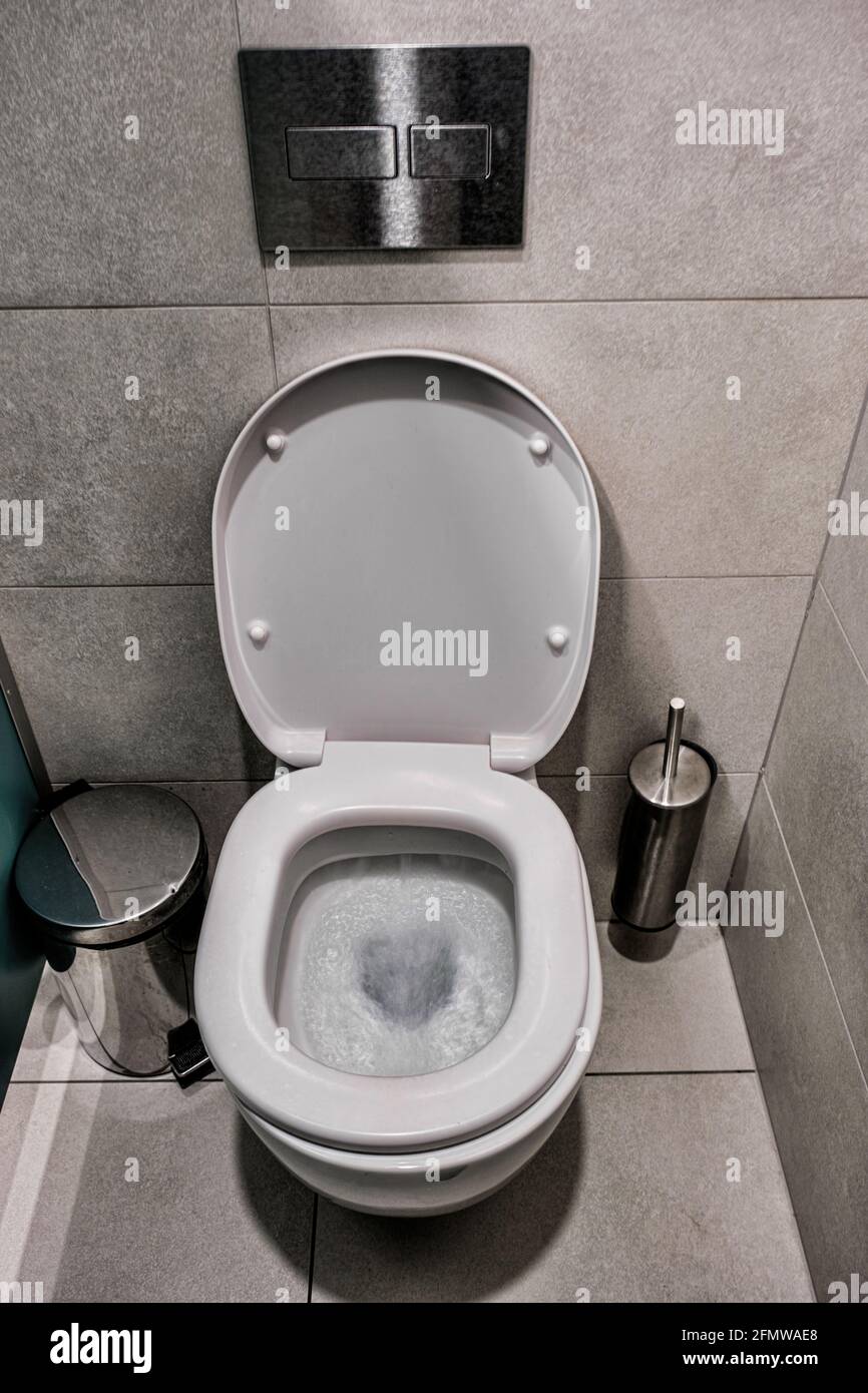flushing water in the toilet Stock Photo - Alamy