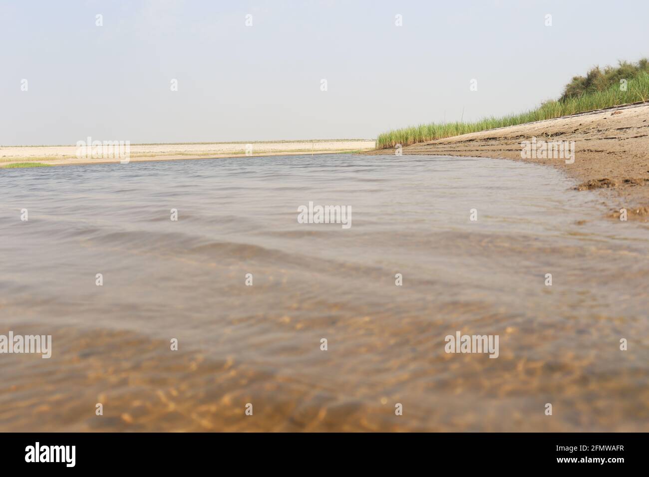 water and beach on river with sky Stock Photo - Alamy