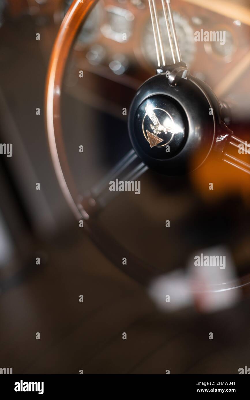 Shiny Wooden Steering Wheel and blur dashboard through car's window ...