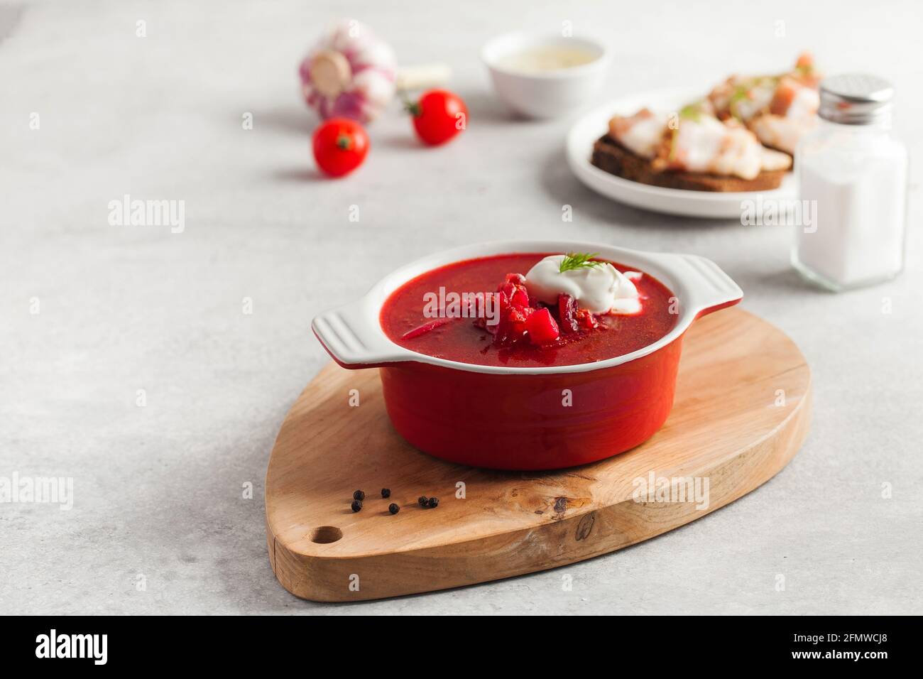 Delicious fresh red borscht, dark bread with lard and salt on kitchen ...