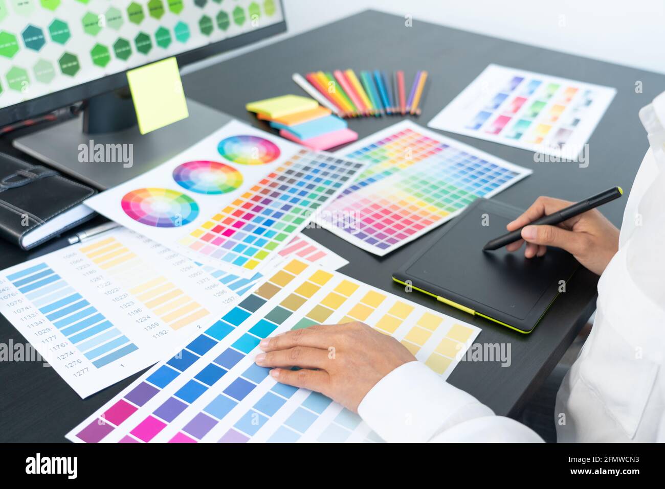 creative graphic designer choosing color scale for editing artwork ...