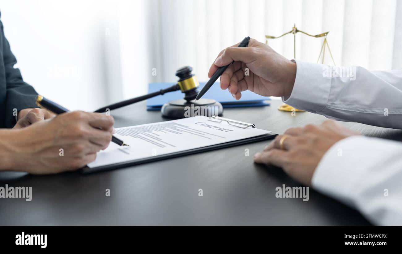 law,libra scale and hammer on the table, 2 lawyers are discussing about ...