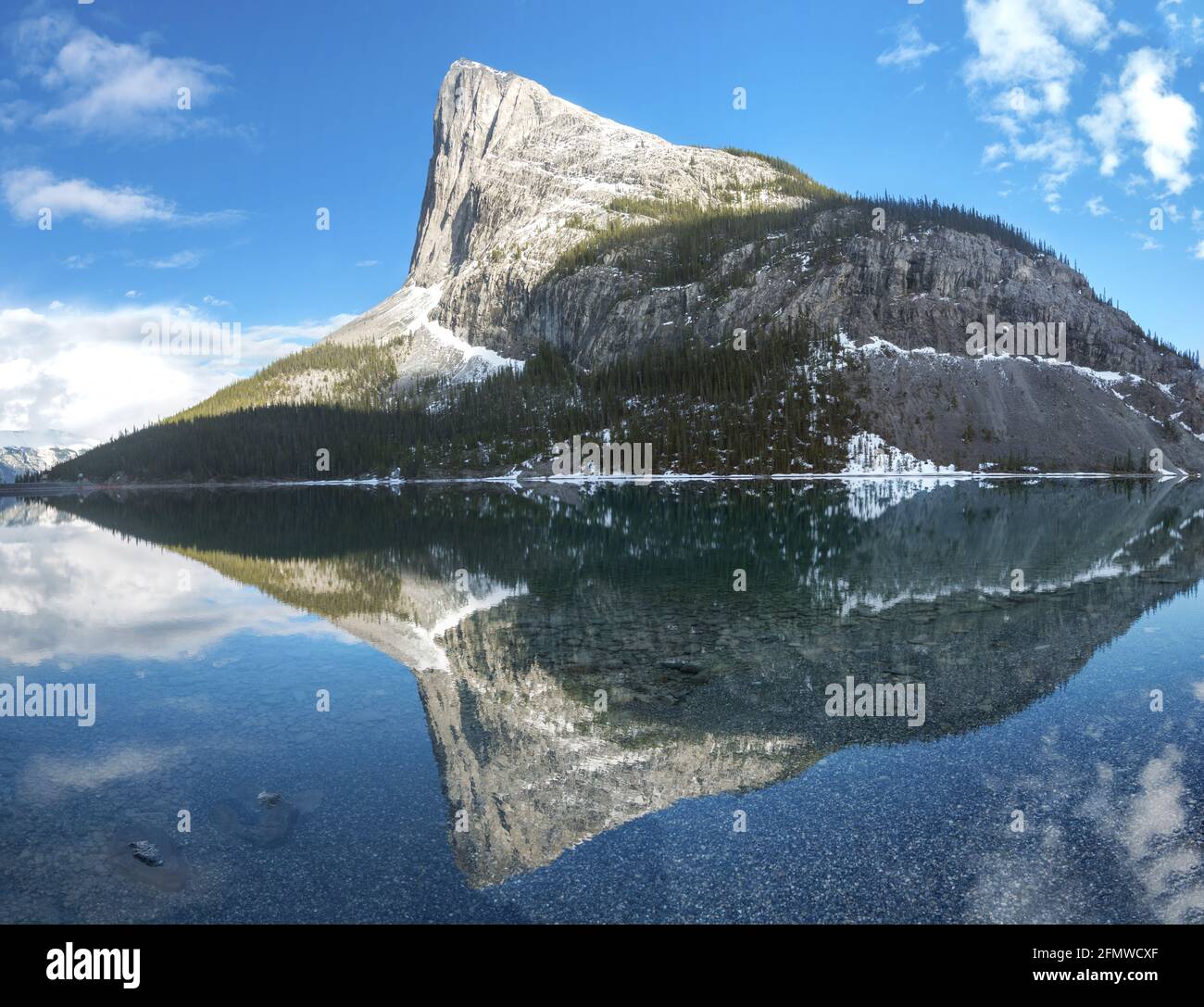 Ha Ling Mountain Peak reflected in calm blue water of Whiteman Gap Lake ...