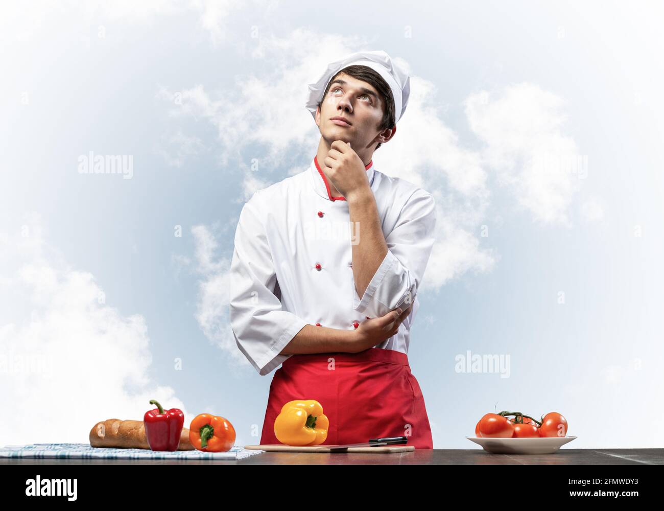 Young male chef standing with folded arms Stock Photo - Alamy
