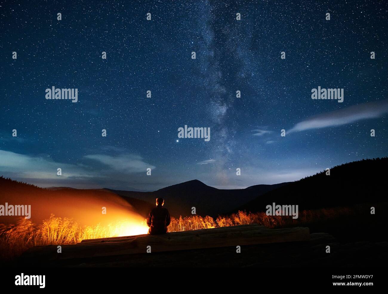 Man sitting near fire hi-res stock photography and images - Alamy