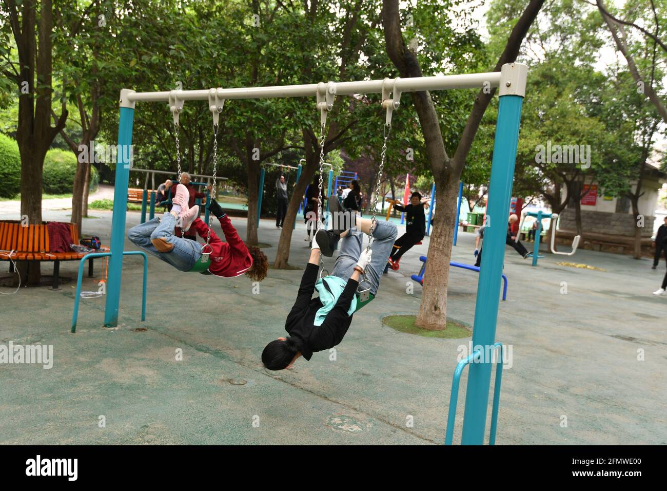Fuyang, China. 12th May, 2021. People use public fitness equipment to ...