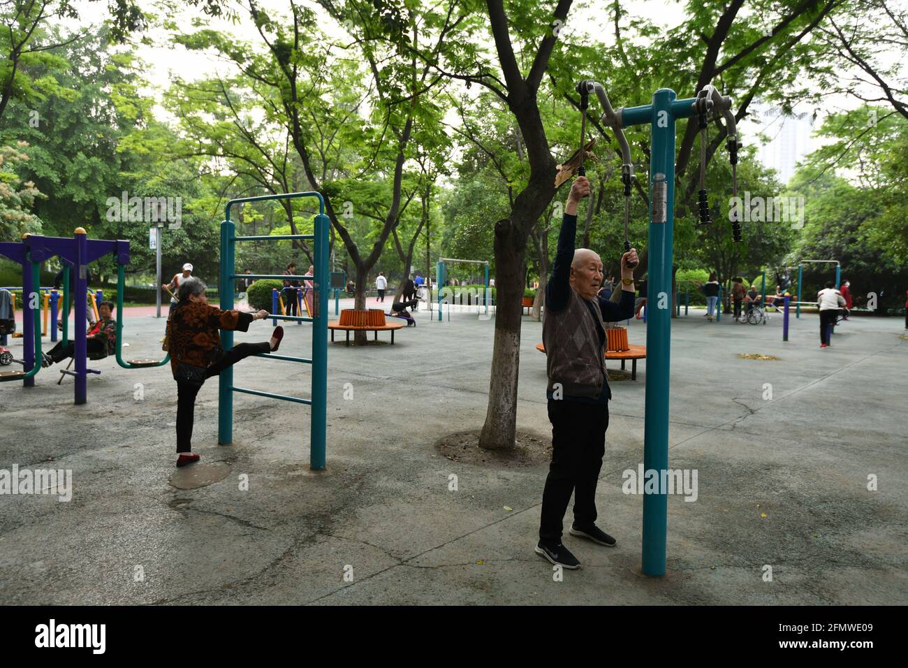 Fuyang, China. 12th May, 2021. Old people use public fitness equipment ...