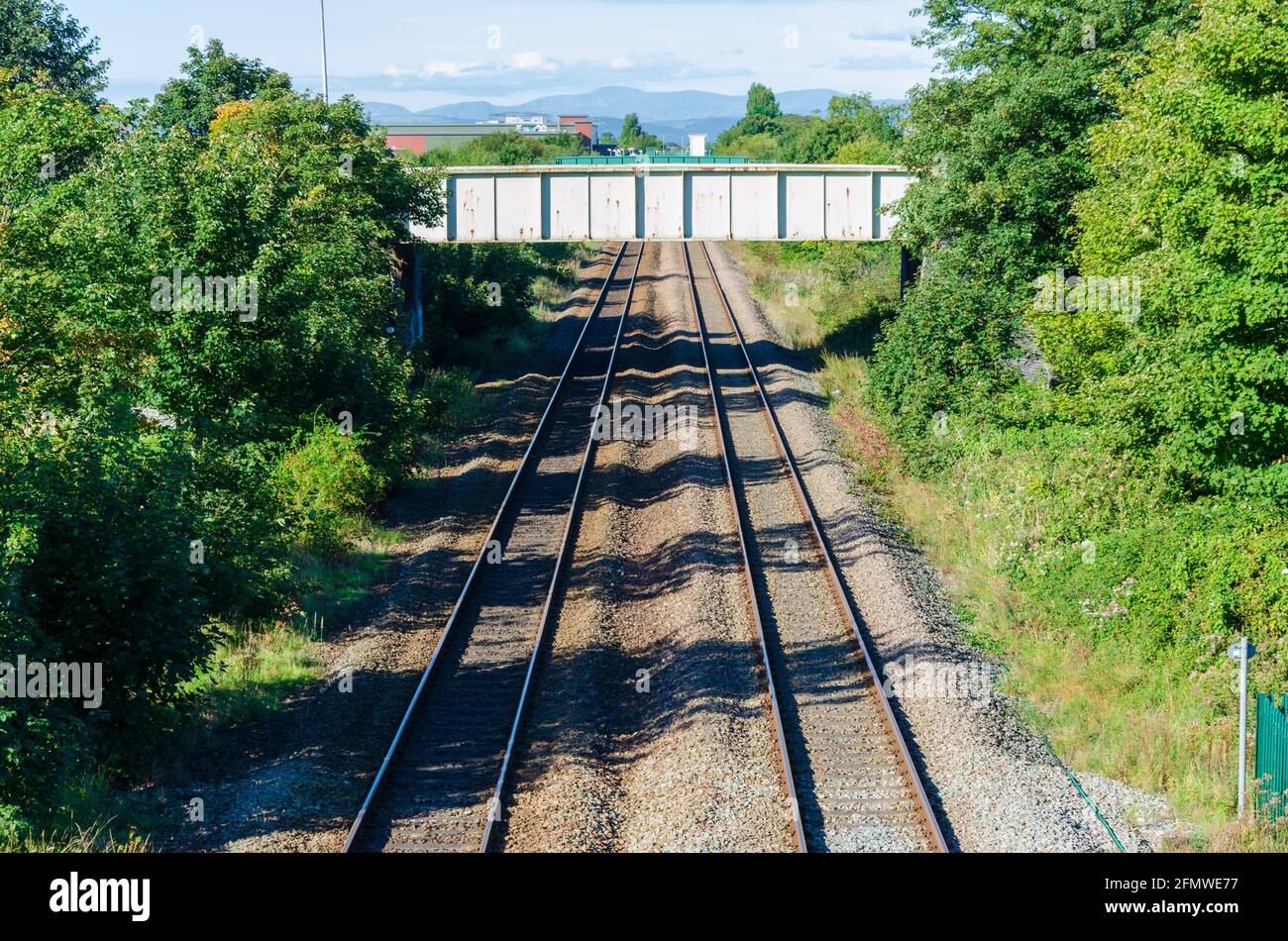 A two line section of railway track with a metal road bridge, seen from ...