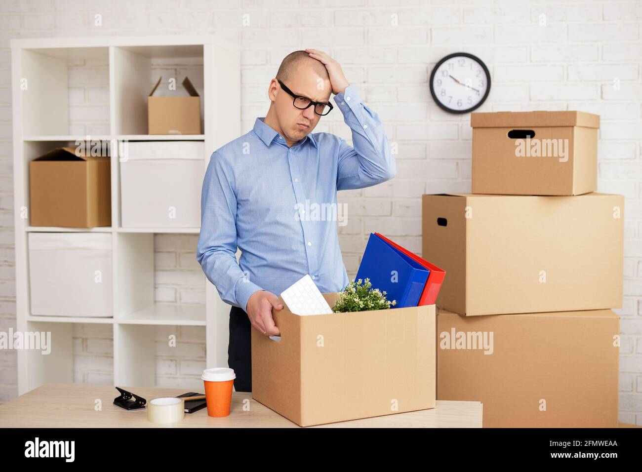 portrait of sad man packing boxes after dismissal in office Stock Photo ...