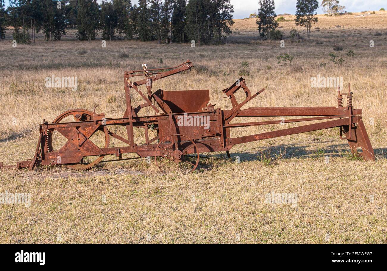 Old rusty farm implement abandoned in field Stock Photo - Alamy