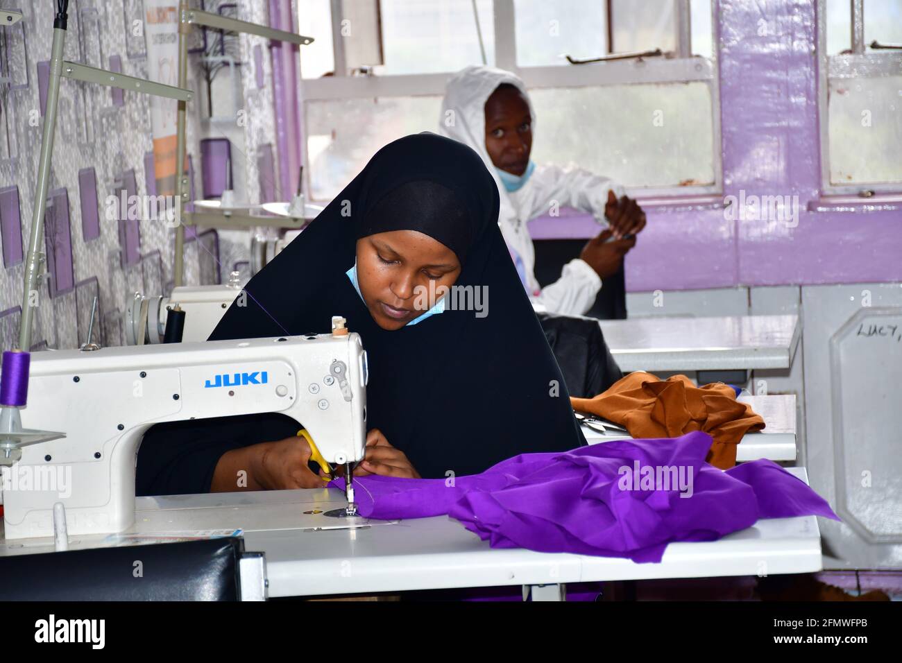 African seamstress sews clothes. Workplace of tailor Stock Photo - Alamy