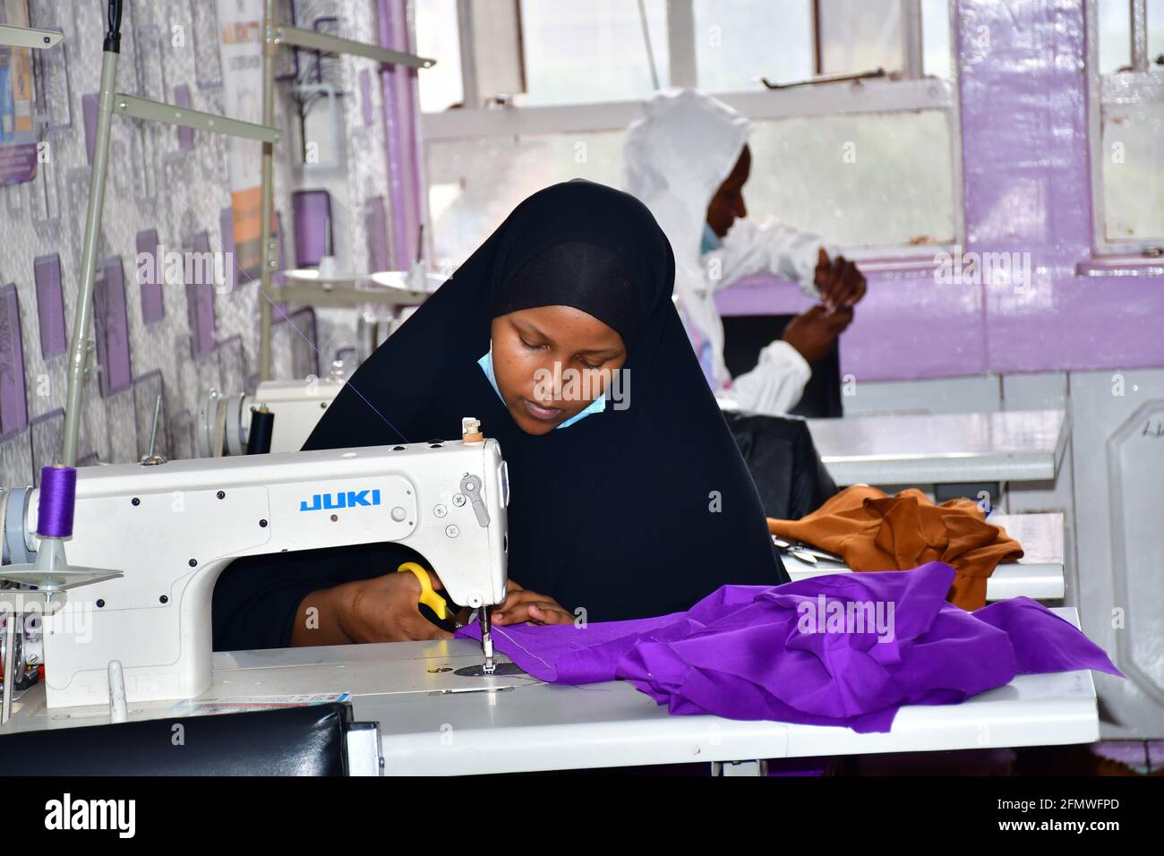 African seamstress sews clothes. Workplace of tailor Stock Photo - Alamy