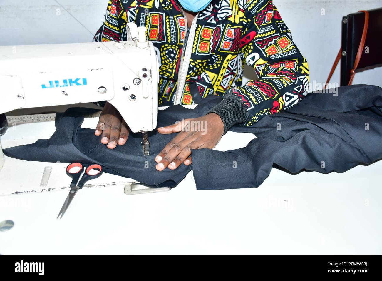 African seamstress sews clothes. Workplace of tailor Stock Photo - Alamy