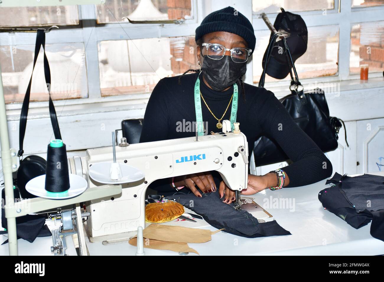 African seamstress sews clothes. Workplace of tailor Stock Photo - Alamy