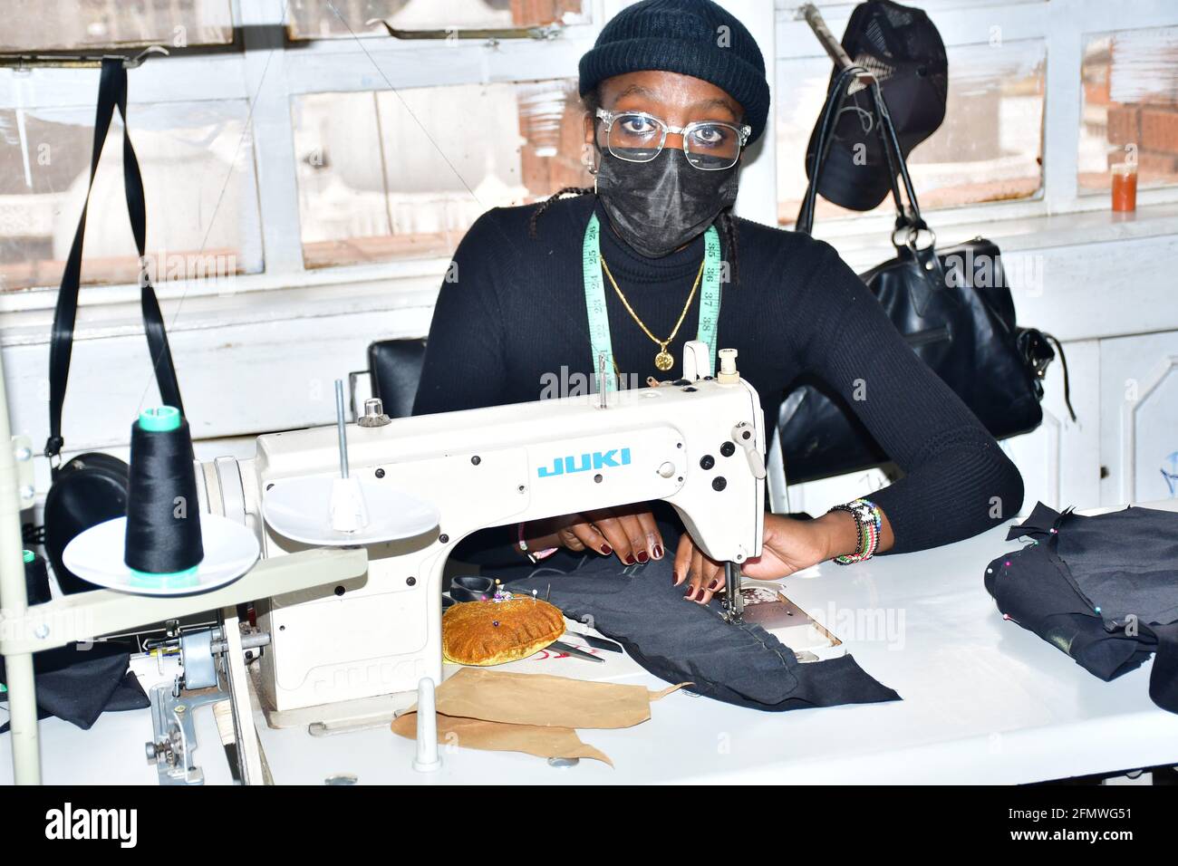 African seamstress sews clothes. Workplace of tailor Stock Photo - Alamy